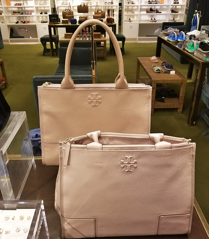 Tory Burch bags posed like museum pieces, tempting you to explain to your spouse why beige is absolutely a different color than the three you already own.