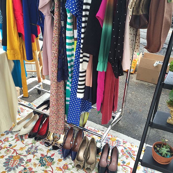 A rainbow of dresses sways in the gentle breeze, each hanger holding possibilities for someone's next favorite outfit.