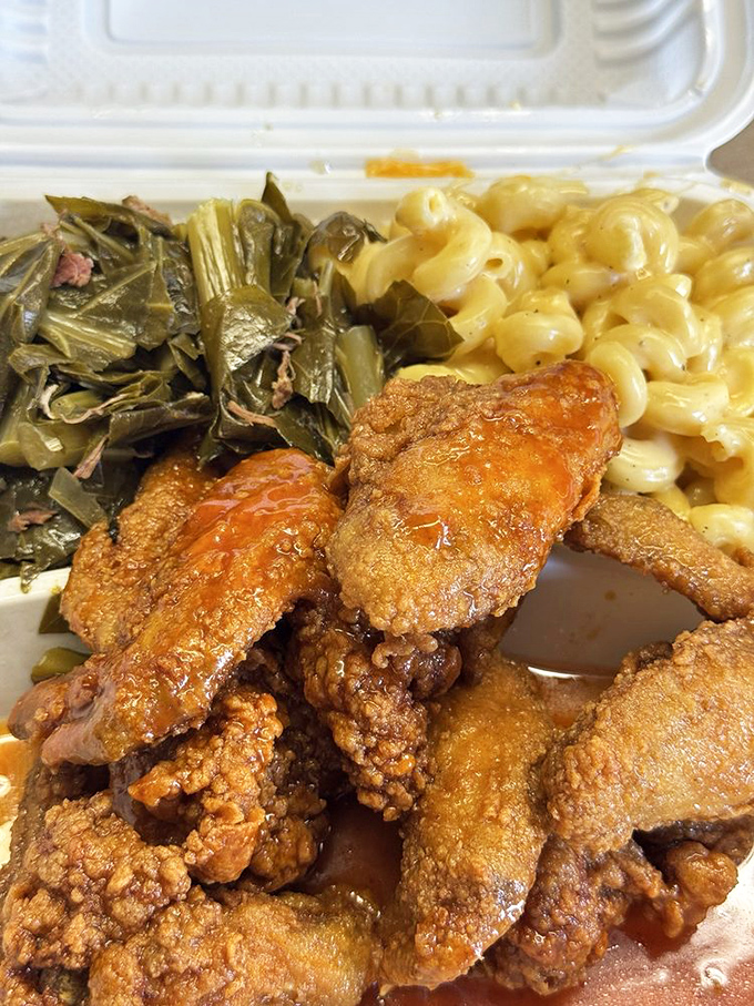 Hot honey chicken wings with collard greens and mac and cheese&mdash;the holy trinity of Southern comfort. Napkins are not optional.