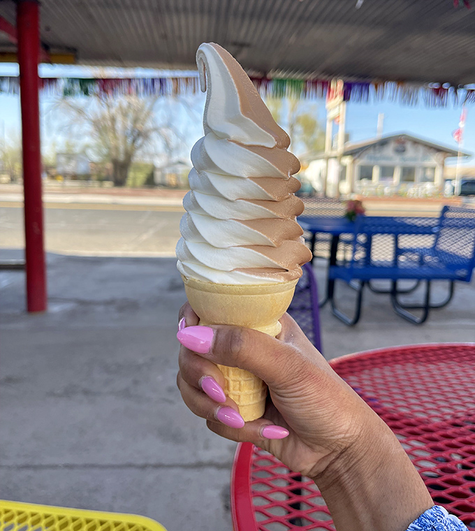Soft-serve ice cream that stands tall and proud, like a dairy monument to summer days when the only serious decision was chocolate or vanilla.