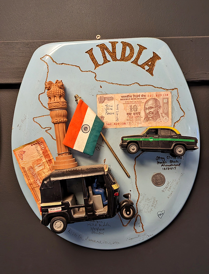 This India-themed seat features currency, miniature vehicles, and national symbols&mdash;a porcelain passport to the subcontinent.