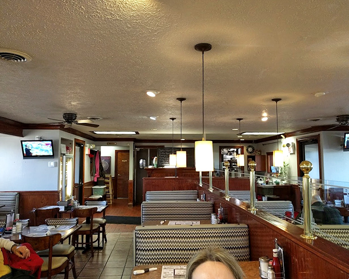 The dining room where countless family celebrations and morning coffee rituals have unfolded. Notice the pendant lights adding a touch of warmth.