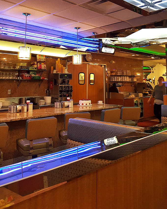 The counter area buzzes with activity while a cake stands proudly in the background, patiently waiting for its moment of glory.
