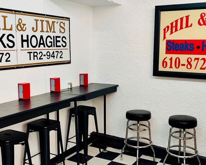 Counter seating that invites you to stay awhile. The black stools against that iconic floor create the perfect stage for sandwich appreciation.