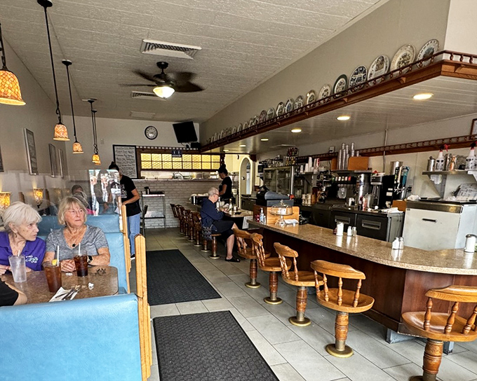 The counter seating offers front-row tickets to the breakfast show. Where regulars become family and coffee cups are never empty.