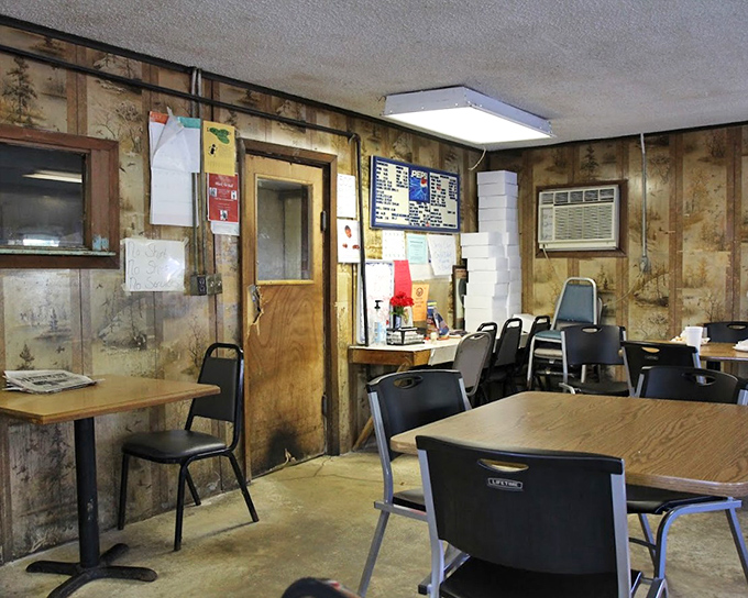 The dining area where conversations pause mid-sentence when the food arrives. Those wood-paneled walls have heard it all.