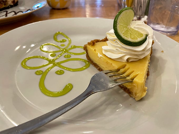 Key lime pie with that signature green swirl &ndash; tangy, sweet, and wearing a dollop of whipped cream like a jaunty beret.