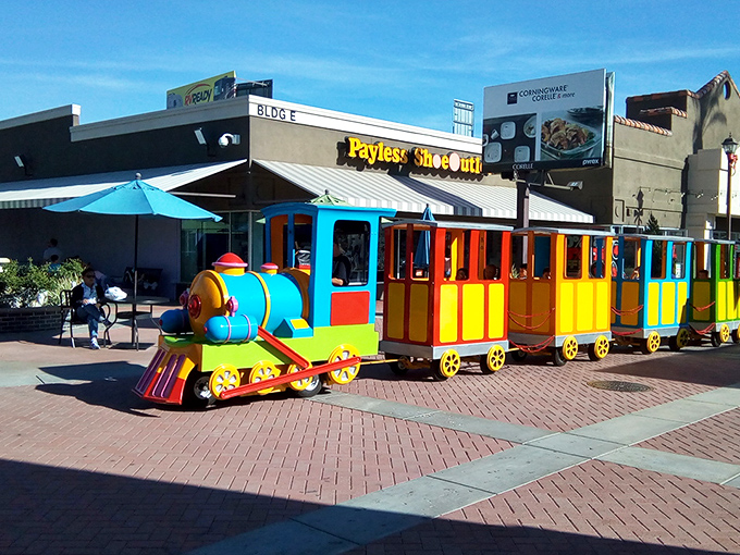 The colorful kiddie train &ndash; keeping the little ones entertained while you debate whether you really need another pair of discounted designer sunglasses.