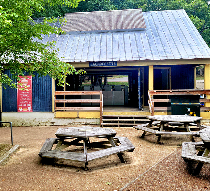 The park's launderette surrounded by picnic tables—because even in paradise, socks eventually need washing and stories need sharing.