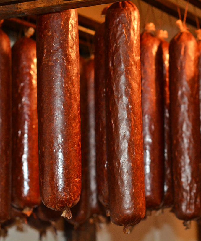 Sausages hanging like edible stalactites in a cave of culinary wonders. Each one a testament to generations of smoking expertise.