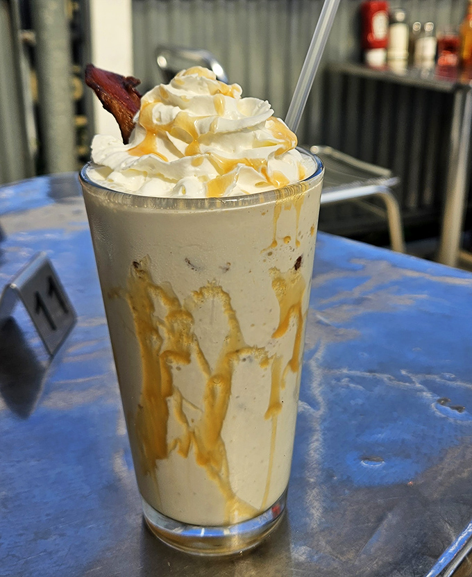 This isn't just a milkshake&mdash;it's dessert in a glass, topped with whipped cream and what appears to be candied bacon. Sweet meets savory!
