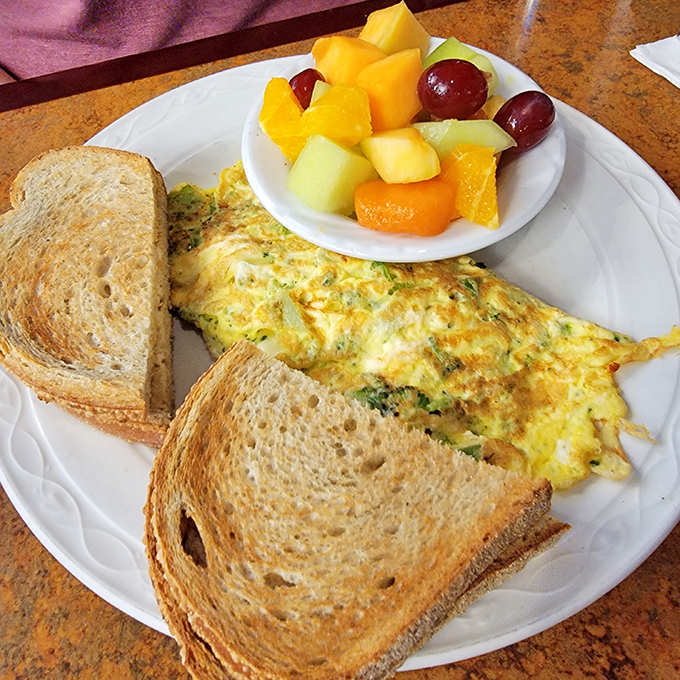 An omelet that's mastered the delicate balance between fluffy and substantial. The fresh fruit side isn't just healthy&mdash;it's absolution for the bacon you'll inevitably order.