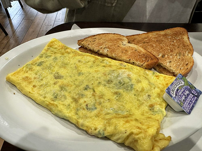 This omelet could end breakfast arguments worldwide. Folded like a yellow letter containing a secret message of melted cheese and fillings.