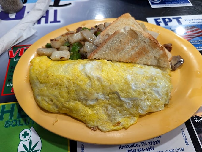 Breakfast artistry at its finest&mdash;a perfectly executed omelet alongside crispy potatoes and toast. Morning fuel that would make any farmer nod in approval.