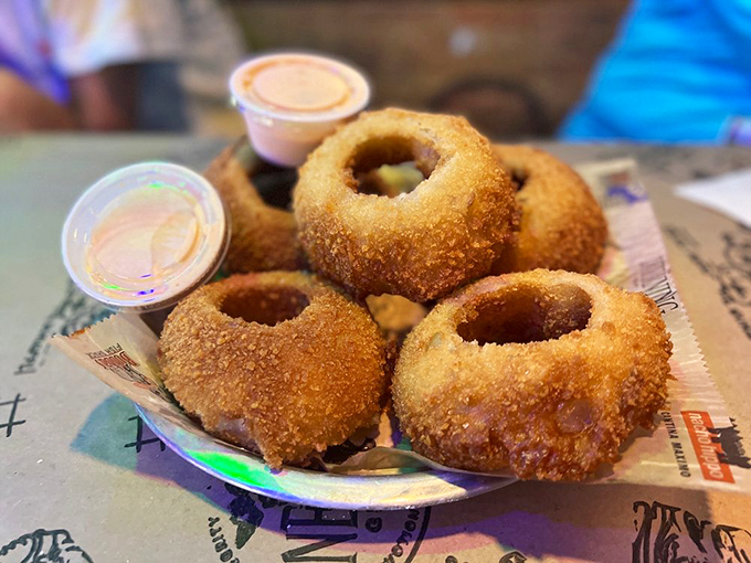 Onion rings with the structural integrity of Olympic gold medals. The perfect balance of crispy exterior and sweet, tender onion that surrenders at first bite.
