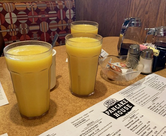 Fresh orange juice in generous glasses—liquid sunshine to wash down whatever breakfast masterpiece you've chosen. Vitamin C never looked so inviting.