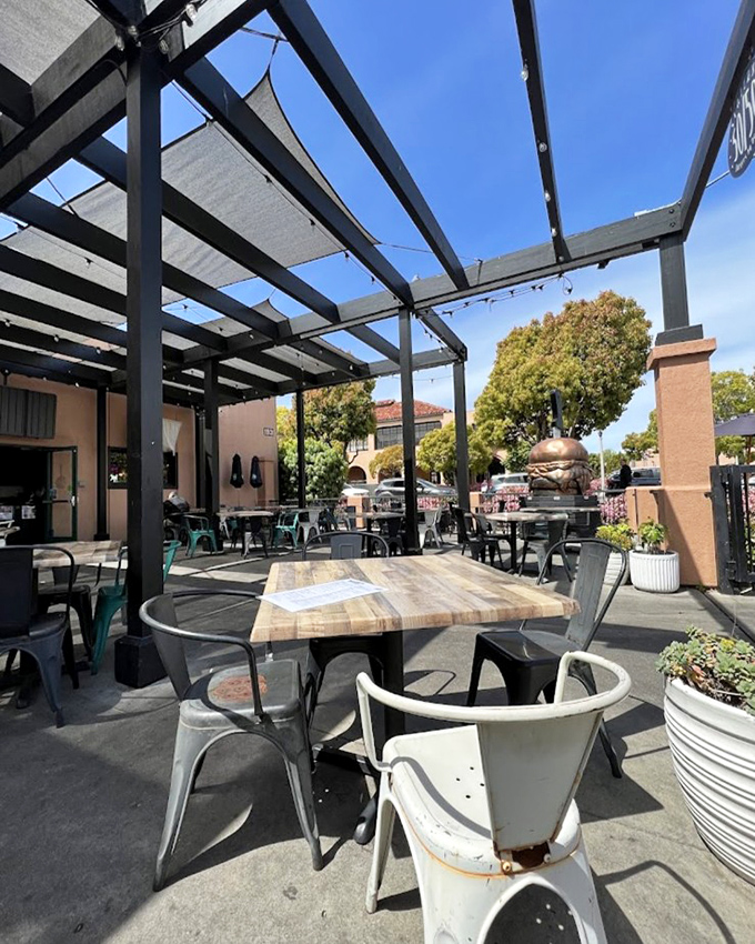 California dining at its finest – sunshine overhead, rustic wooden tables, and the knowledge that a burger masterpiece awaits just steps away.