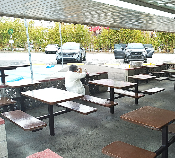 The outdoor seating area isn't winning design awards, but those concrete tables have witnessed more moments of sandwich bliss than most therapists.