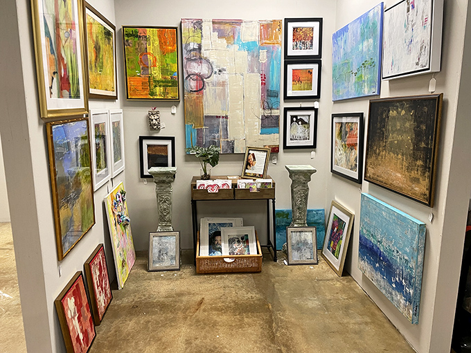 An art lover's corner where abstract expressions meet traditional landscapes. Your walls are begging you to bring something home.