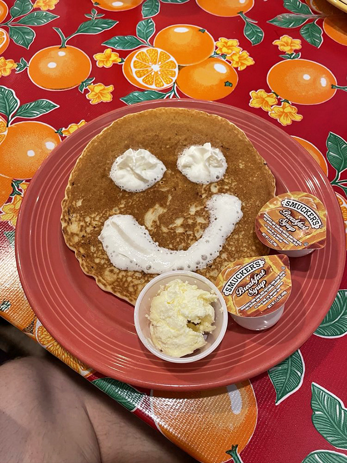 This pancake's smiley face says what we're all thinking: breakfast joy is the best kind of joy.