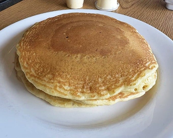Pancakes so perfectly golden they belong in Fort Knox&mdash;fluffy enough to use as a pillow if you weren't so busy devouring them.