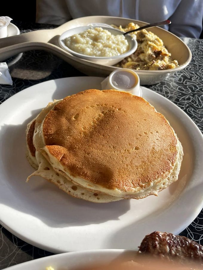 Pancakes so perfectly golden they deserve their own spotlight, with grits standing by for supporting actor.