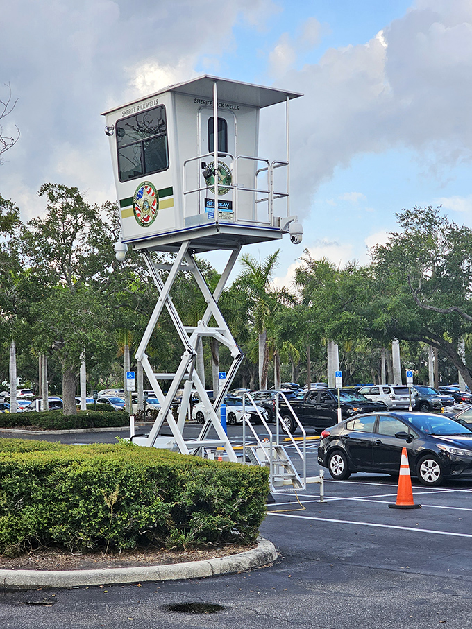 Even the security tower has resort vibes &ndash; watching over a sea of parked cars whose trunks will soon be filled with shopping victories.