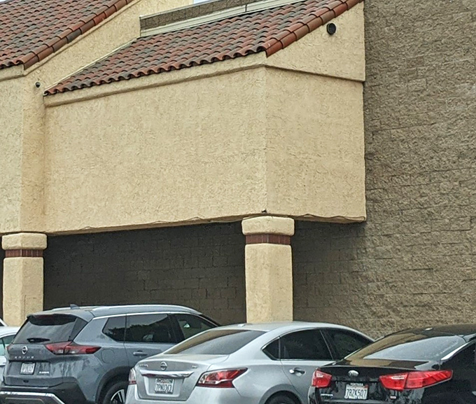 The Spanish-style architecture continues around the building. That parking lot has witnessed countless shoppers arriving with empty trunks and leaving with full hearts. 