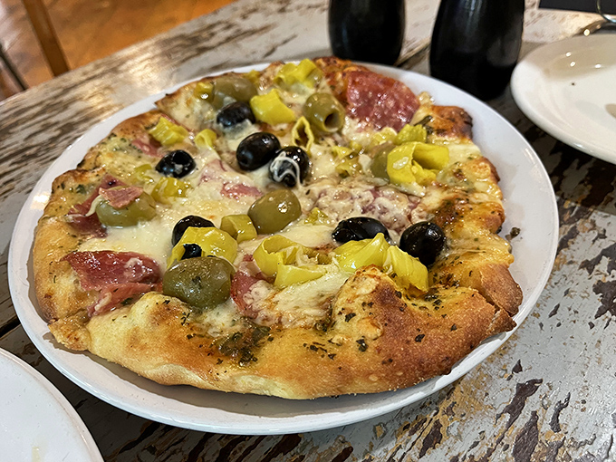 This isn't just any pizza—it's an olive lover's dream, with a crust that crackles then yields like a perfect first date.