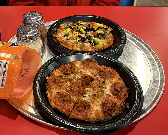 Personal pan pizzas served in cast iron – proof that good things come in small packages, especially when those packages are bubbling with cheese.