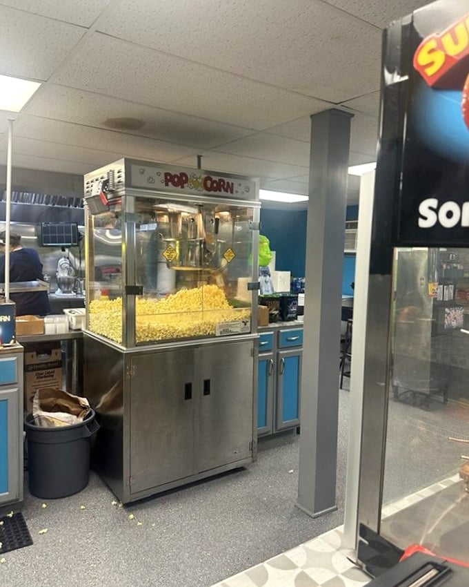 Inside the concession area, that classic popcorn machine works overtime to feed hungry movie-goers.
