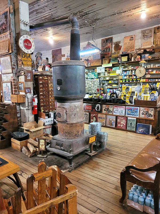 The pot-bellied stove stands sentinel in the center, having witnessed decades of gossip, weather predictions, and the eternal debate about proper cornbread technique.