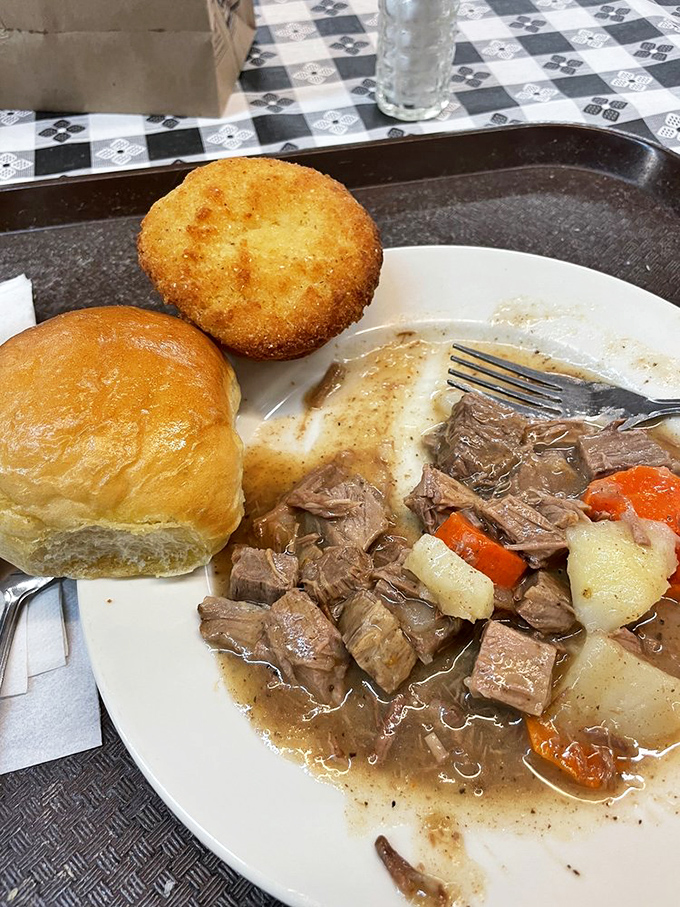Pot roast that doesn't just fall apart&mdash;it surrenders completely, alongside a cornbread muffin standing guard.