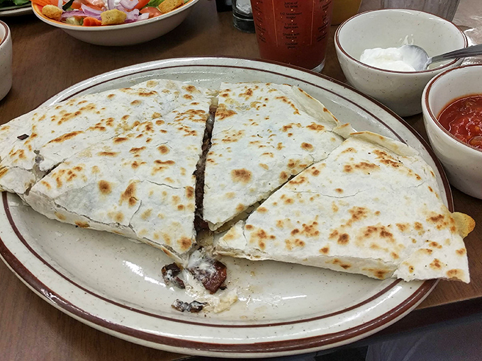 A quesadilla the size of a hubcap, perfectly browned and cut into triangles that reveal its molten interior. Sharing optional but not recommended.