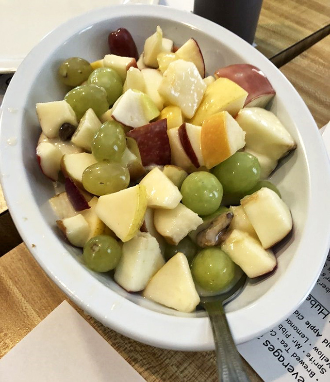 A fruit salad that's having more fun than most people on vacation, with apples and grapes playing nicely together.