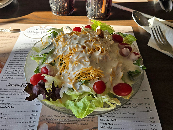 Garden-fresh salad topped with shredded cheese and house dressing&mdash;proof that Amish country knows vegetables aren't just what food eats before becoming dinner.