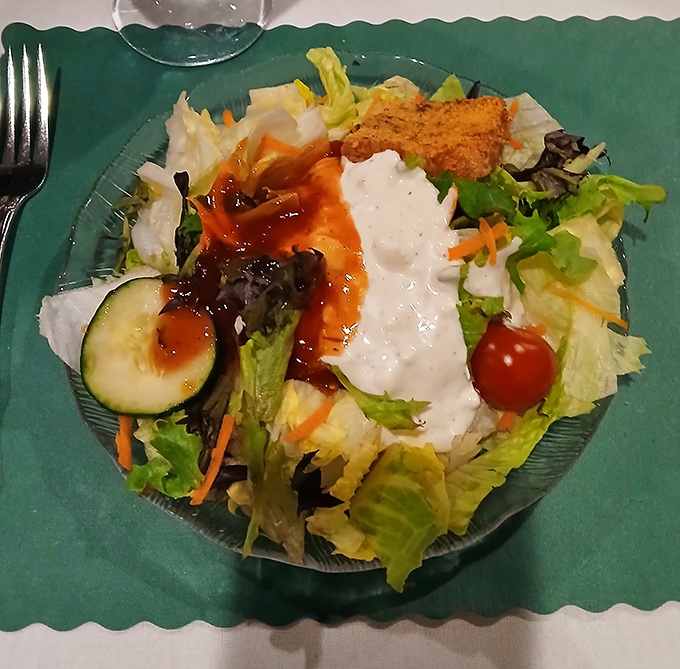 Garden-fresh salad with house dressing &ndash; the opening act that deserves its own standing ovation. Even vegetables dress up for dinner here.