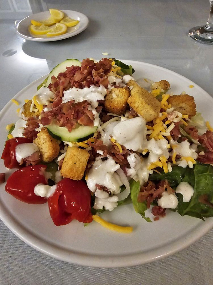 A salad that doesn't apologize for being exactly what it should be: fresh, generous, and loaded with enough bacon and cheese to make your cardiologist wince.
