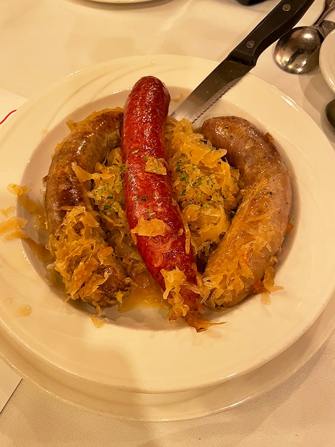 A plate of traditional German sausages nestled on sauerkraut&mdash;proof that Frankenmuth takes its Bavarian heritage seriously and deliciously.