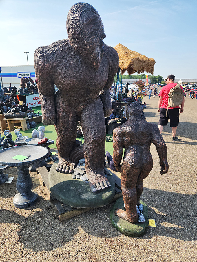 Bigfoot statues stand guard over garden ornaments. Nothing says "refined landscaping" quite like a sasquatch family watching over your petunias.