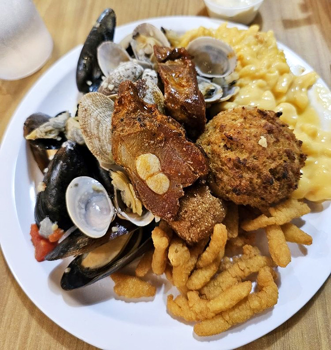 A plate that tells a delicious story: mussels, clams, hush puppies, and mac & cheese sharing real estate in perfect harmony. This is buffet strategy at its finest.