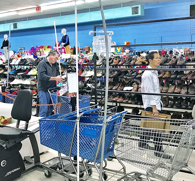 Thrift store anthropology in action&mdash;shoppers navigate the shoe section with the focus of archaeologists uncovering treasures from the recent past.