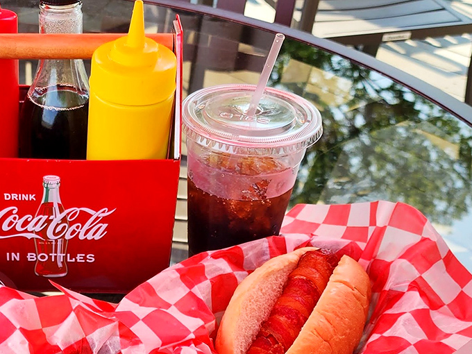 The classic American trinity: Coca-Cola, mustard, and a perfectly dressed dog. Some traditions don't need improving, just celebrating.
