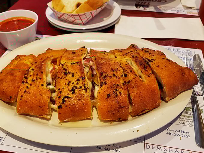 The stromboli arrives like an edible treasure chest&mdash;each slice revealing a perfect harmony of meats, cheese, and dough that puts ordinary sandwiches to shame.