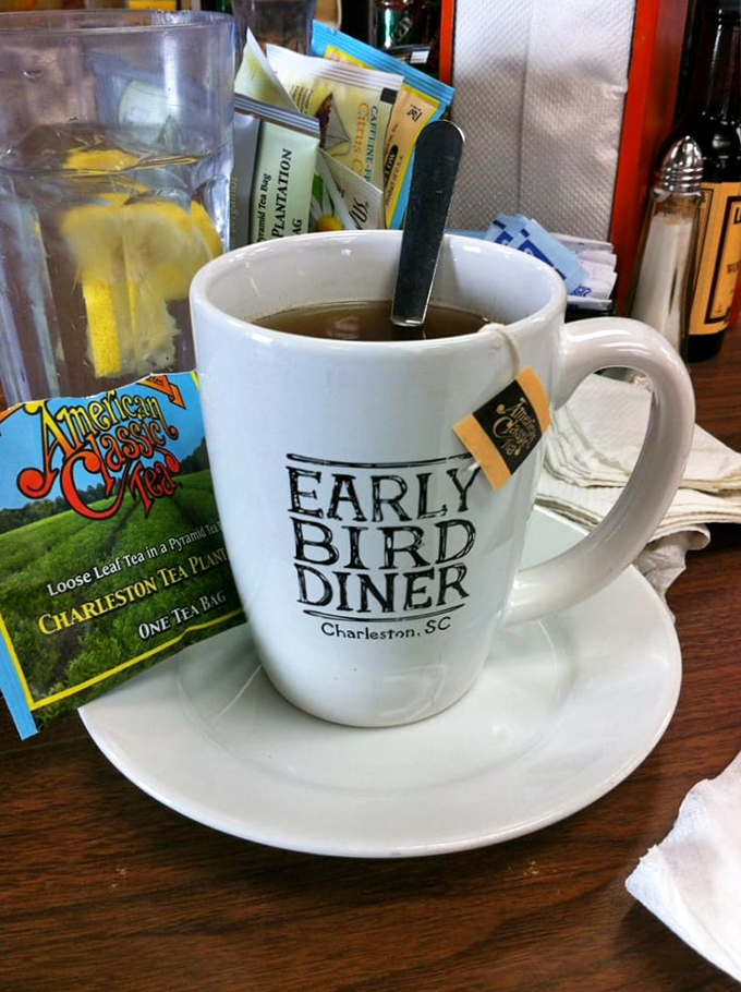 A proper cup of tea served in a branded mug, with Charleston Tea Plantation's American Classic nearby. Some mornings call for something gentler than coffee's electric jolt.