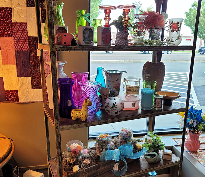 Colorful glassware catches the light like stained glass windows in a cathedral dedicated to the art of repurposing beautiful things.