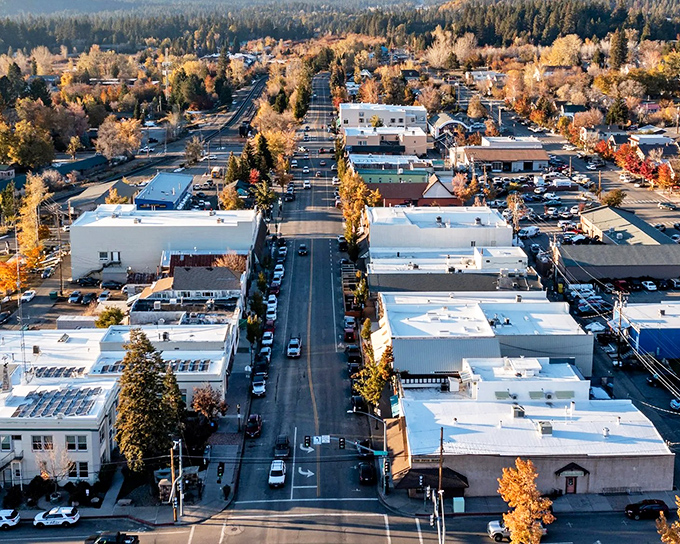 Downtown from above: where "rush hour" means three cars at a stop sign and the tallest structures are the autumn trees.