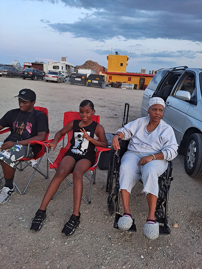 Three generations sharing movie night under the stars - the drive-in experience bridges age gaps better than any streaming service.