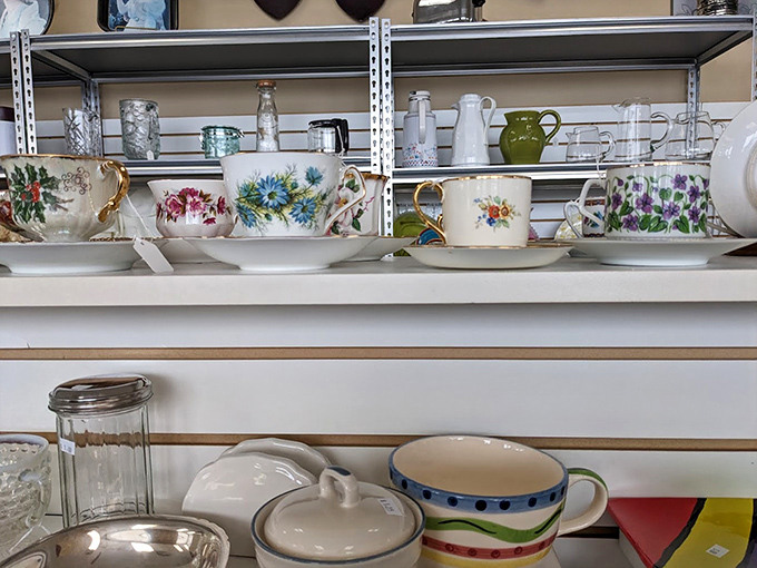 Delicate teacups and saucers from another era line the shelves like porcelain memories. Your grandmother would approve of these floral patterns.