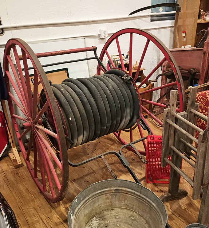 This isn't just a fire hose reel—it's a piece of history that protected communities long before modern equipment. Those red wheels have rolled toward countless emergencies.